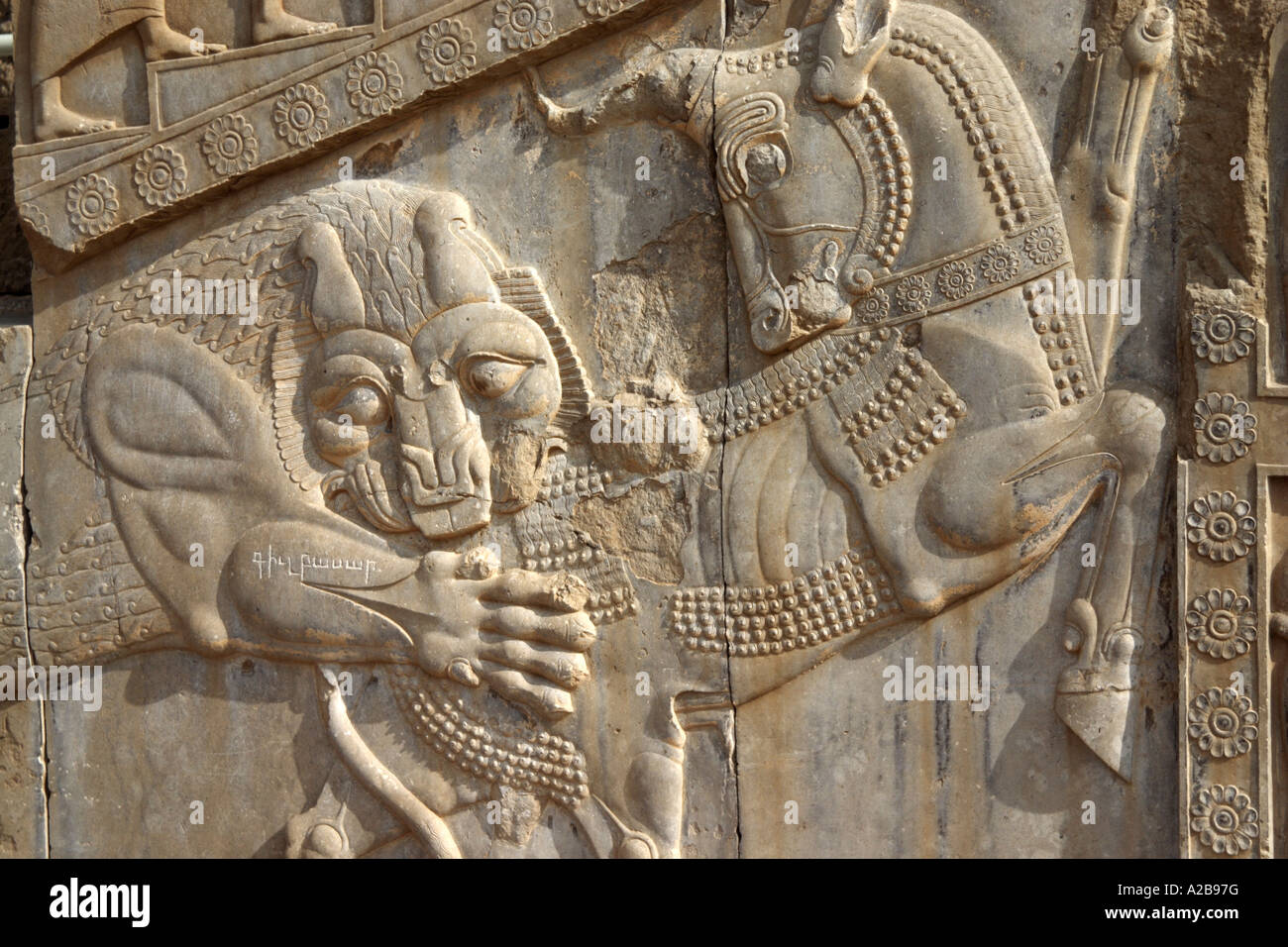 Scene from Persian mythology in the Apadana stairs, Persepolis, Iran ...