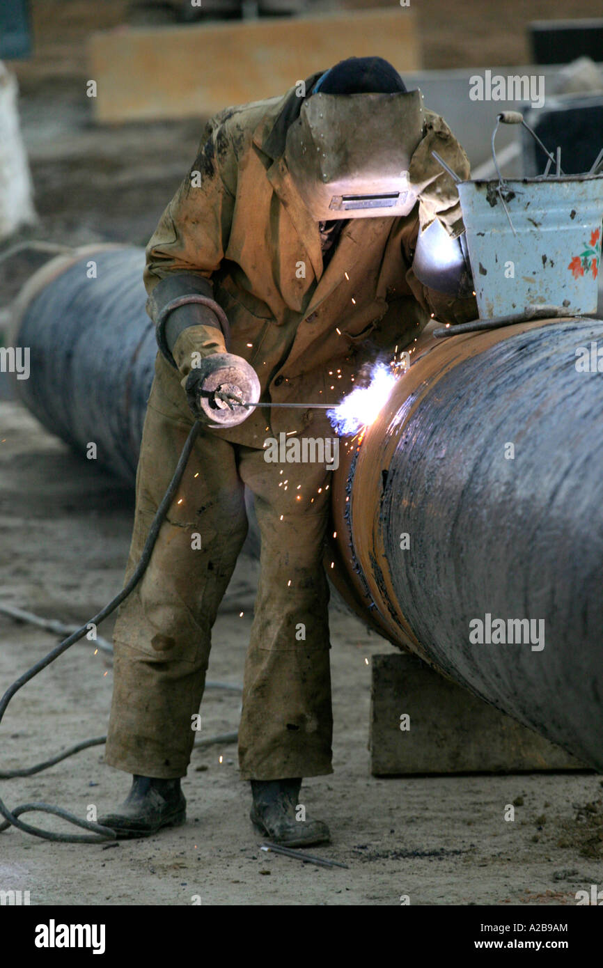 Worker soldering a tube Stock Photo - Alamy