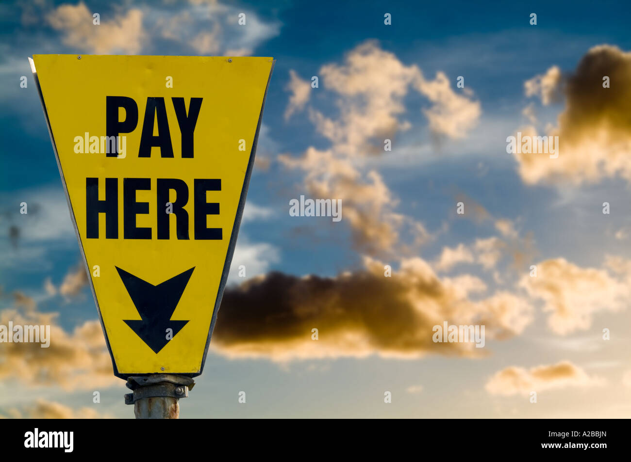 pay here sign with moody sky Stock Photo - Alamy