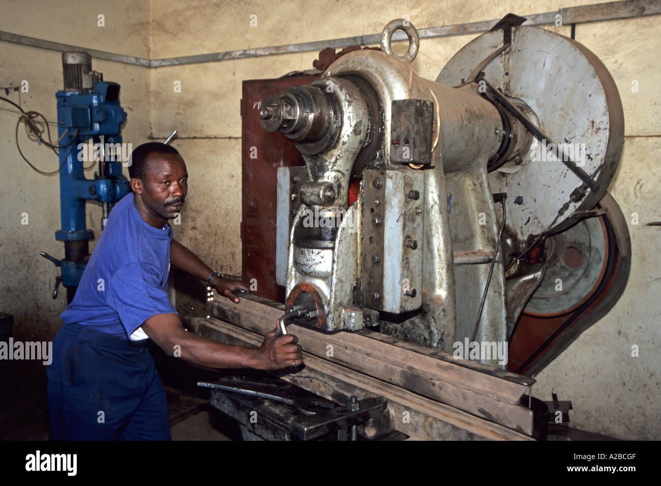 Metal worker at a hydraulic press, Moshi, Tanzania Stock Photo - Alamy