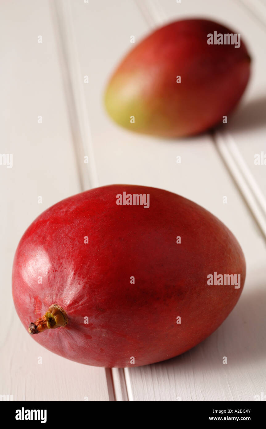 Mangoes on wooden table Stock Photo - Alamy