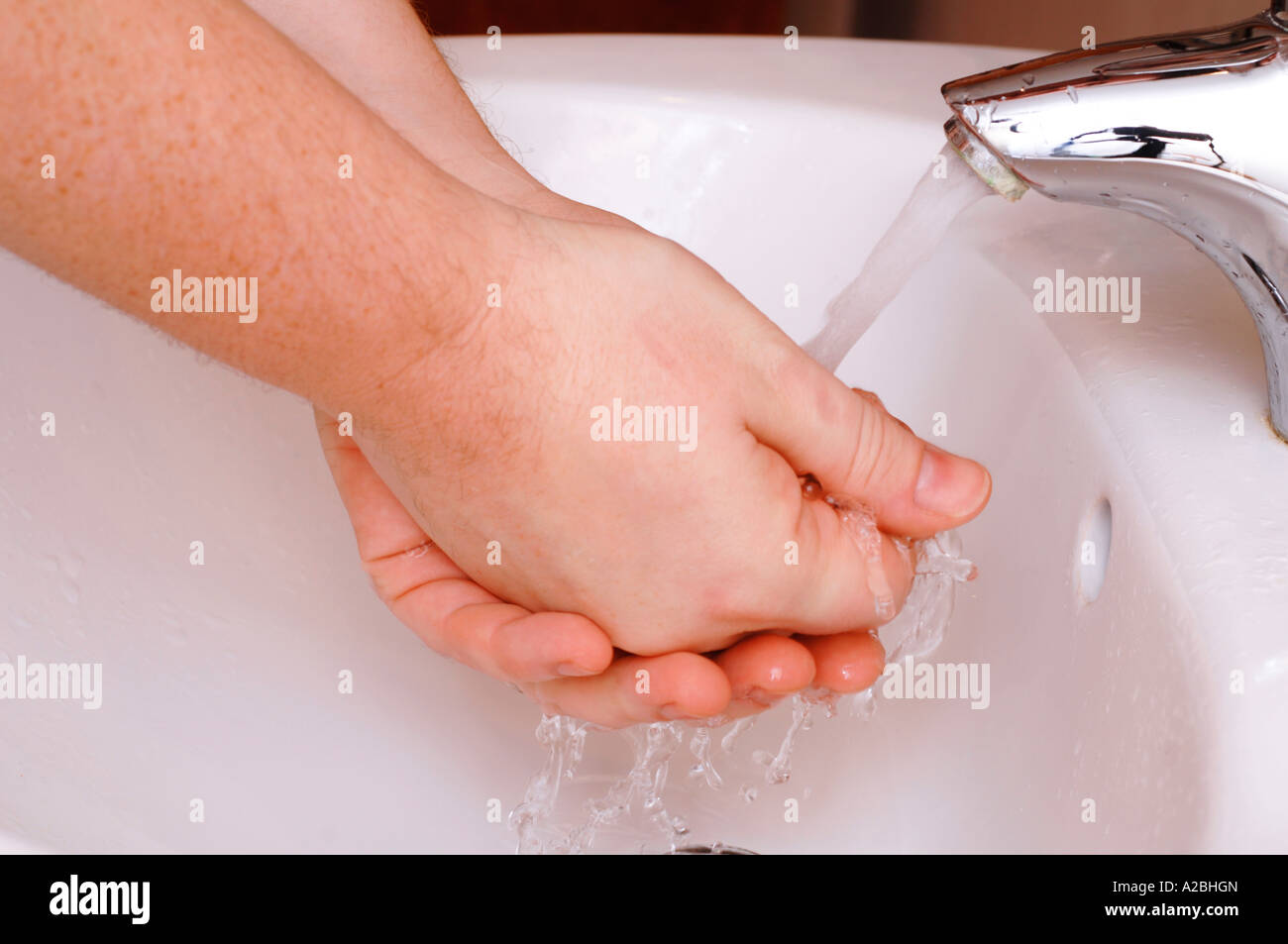 Man washing hands in basin Stock Photo - Alamy