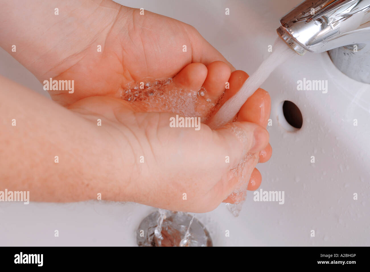 Man washing hands in basin Stock Photo - Alamy