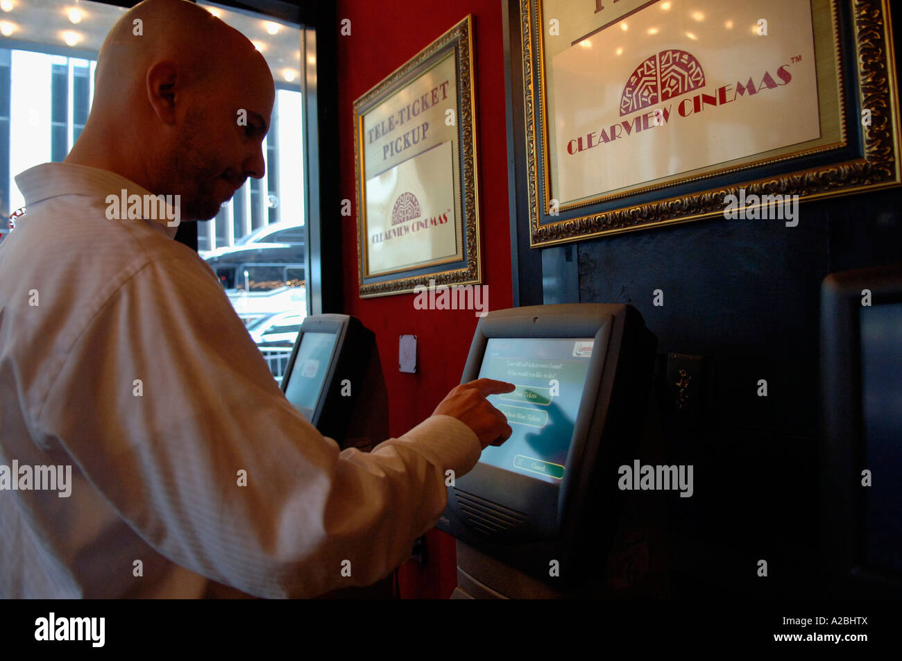 Filmgoer purchases tickets from a lobby kiosk at the Ziegfield Theater ...