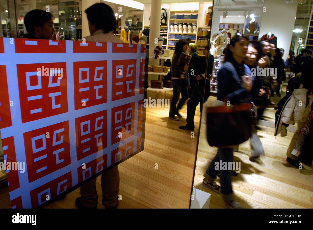 Customers shop at the Uniqlo Global Flagship store in the Soho ...
