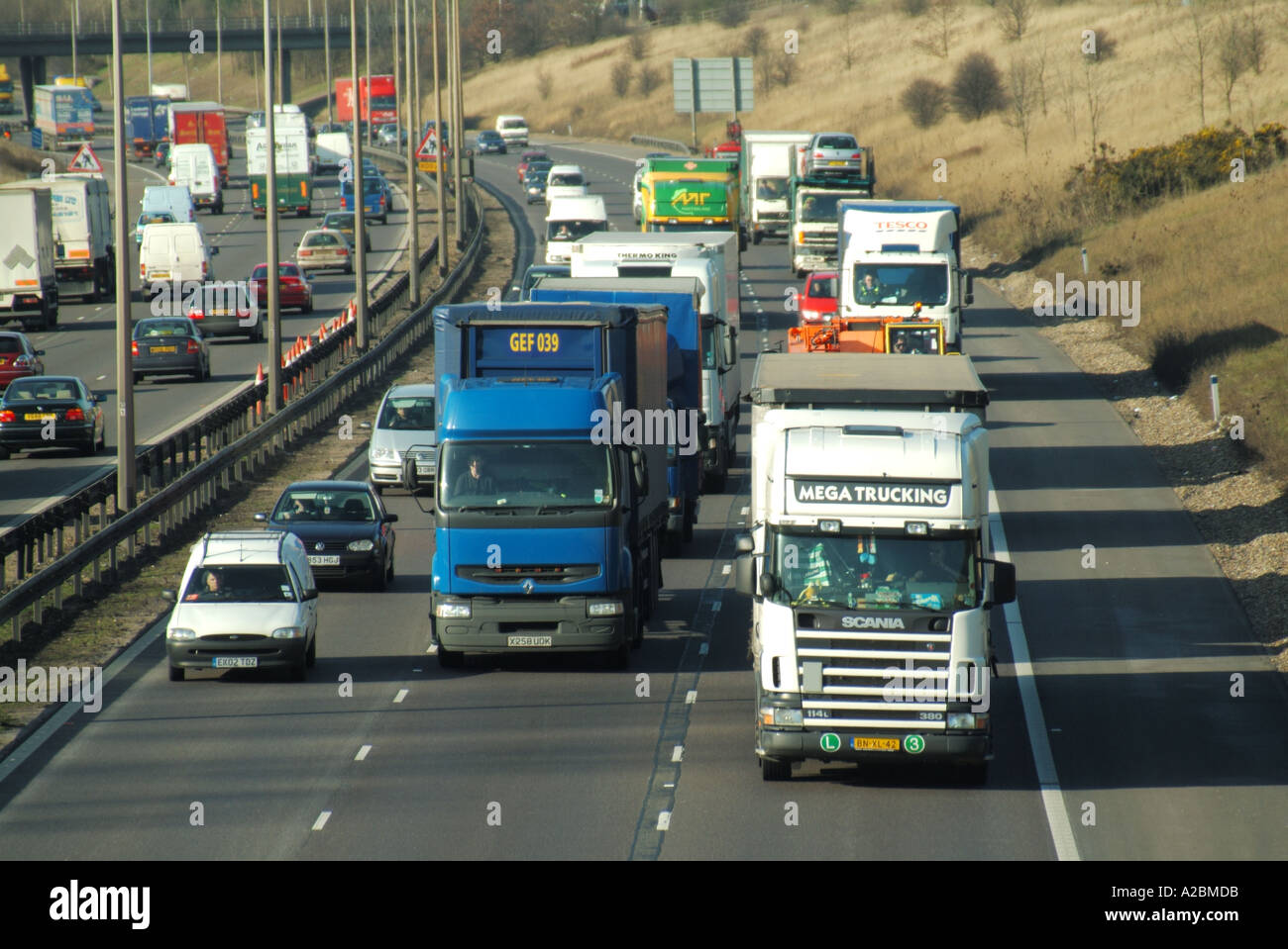Front view hgv lorries trucks articulated trailer traffic driving on ...