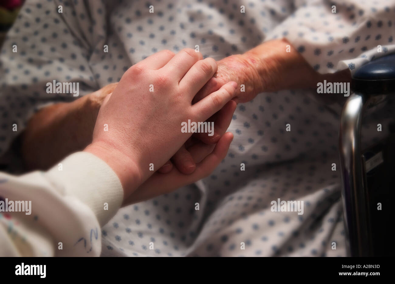 Senior woman in wheelchair holding hands with nurse Stock Photo - Alamy