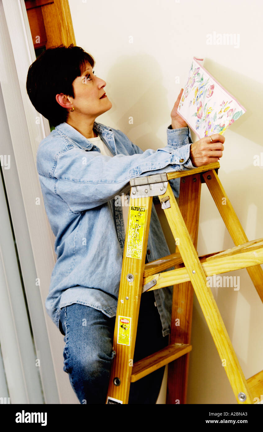 Woman on ladder Stock Photo - Alamy