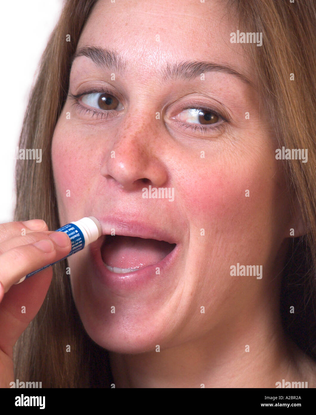 Woman applying moisturizer chapstick hi-res stock photography and ...