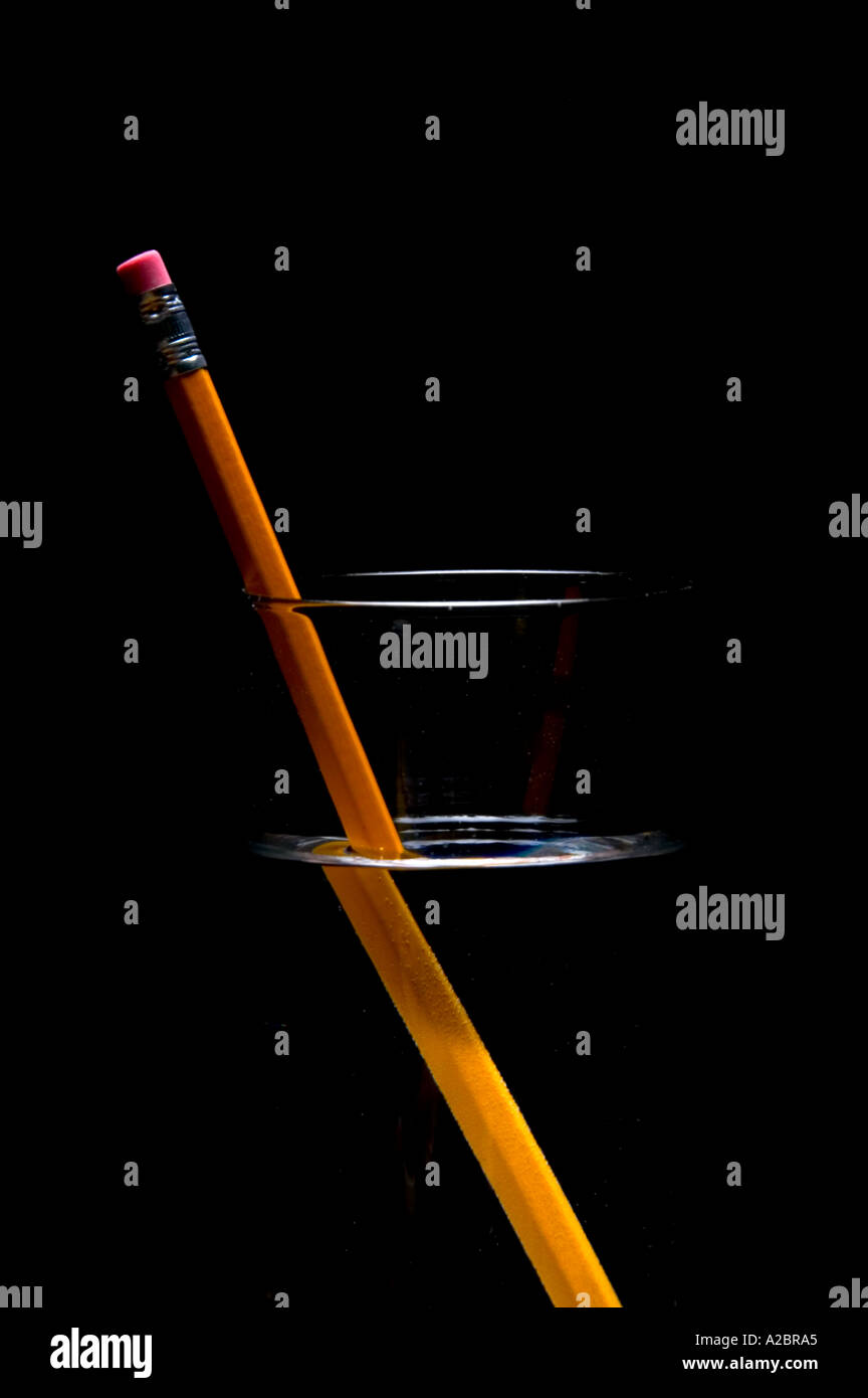 Pencil in glass of water showing light refraction Stock Photo - Alamy