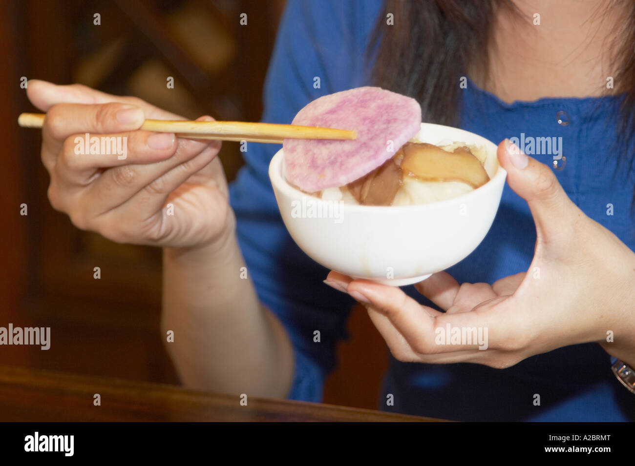 Woman hands using chopsticks hi-res stock photography and images - Alamy
