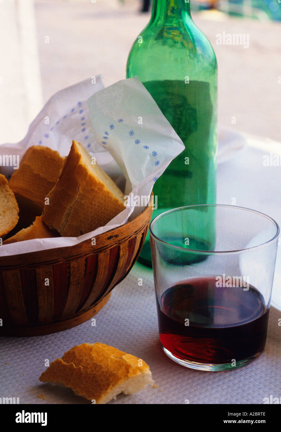 Dining table in a Spanish restaurant or cafe. Bread in a basket an ...