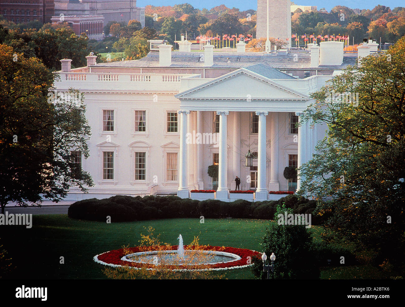 White House in Washington DC seen from above. Circle of flags around ...