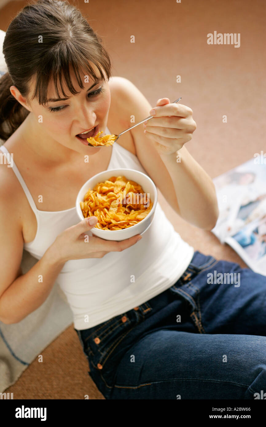 Woman eating cereal Stock Photo - Alamy