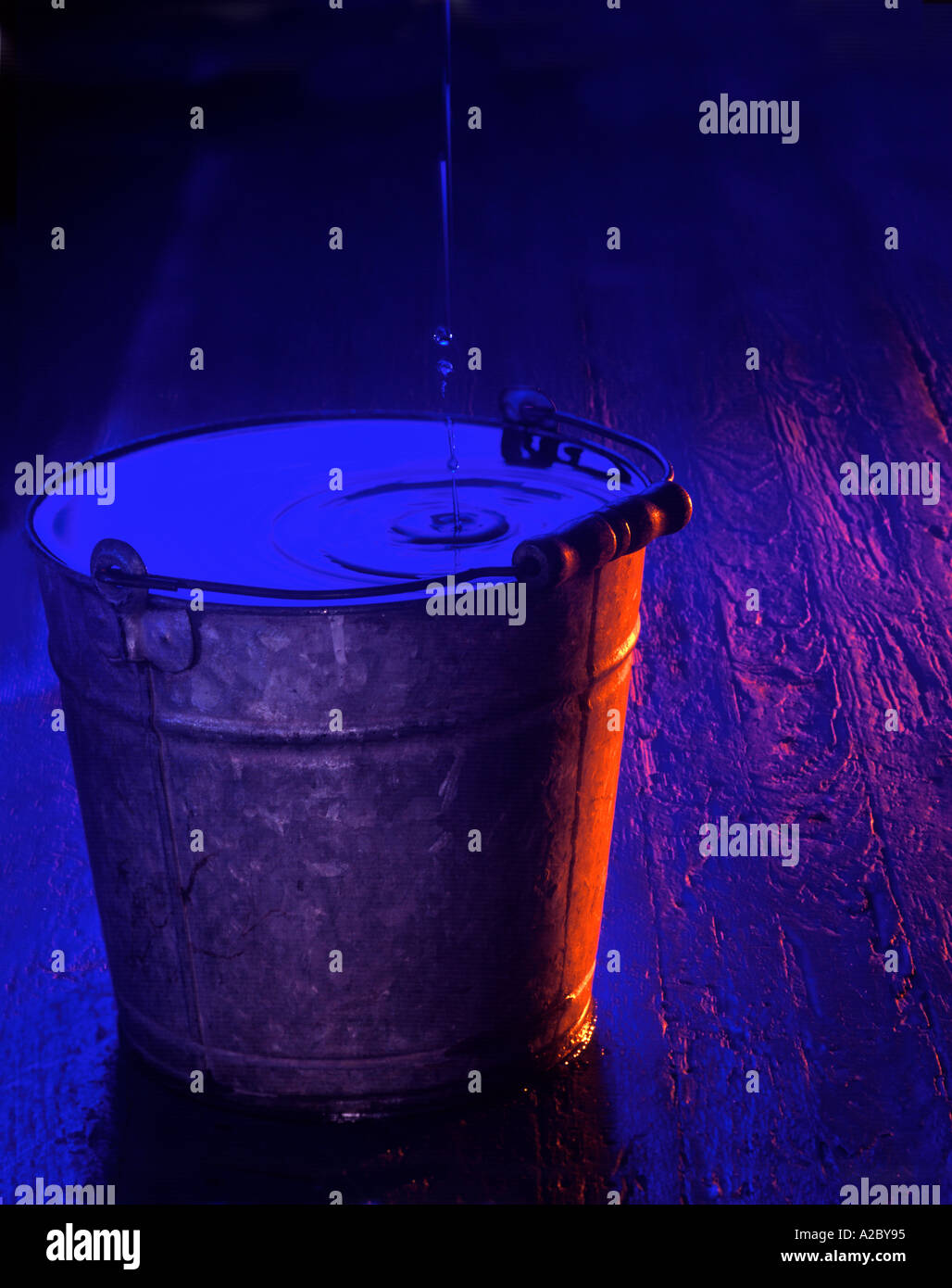 Water Dripping In Steel Bucket From Leaking Roof Stock Photo - Alamy