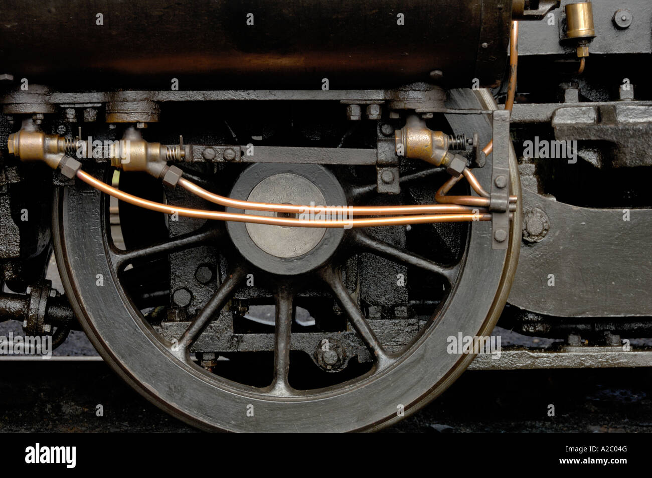 Steam engine detail side view of big metal wheel Stock Photo - Alamy