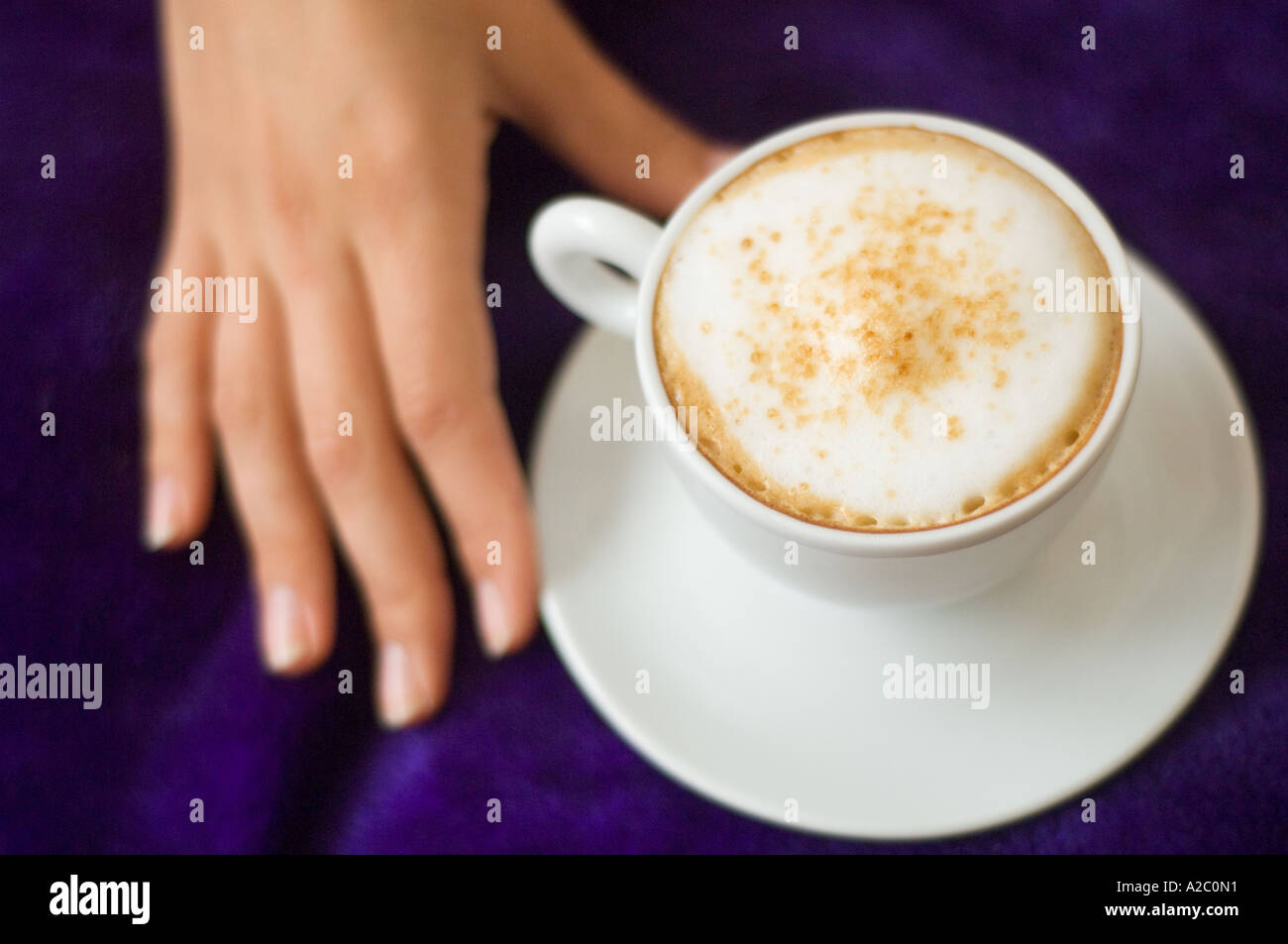 A female hand reaching for a cup of coffee Stock Photo - Alamy