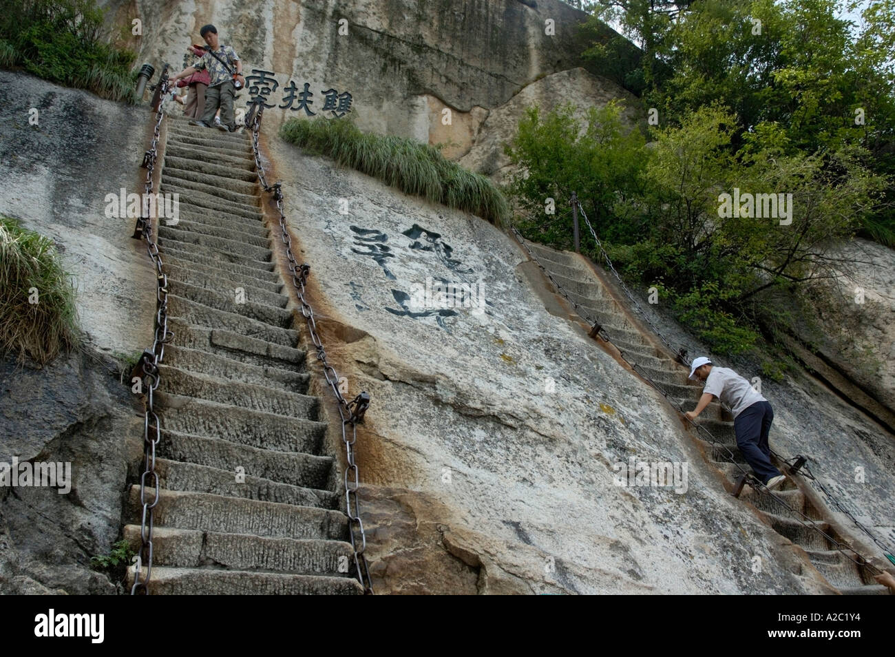 People climbing the stairs on the steep face of Hua Shan, Xian, Shaanxi ...