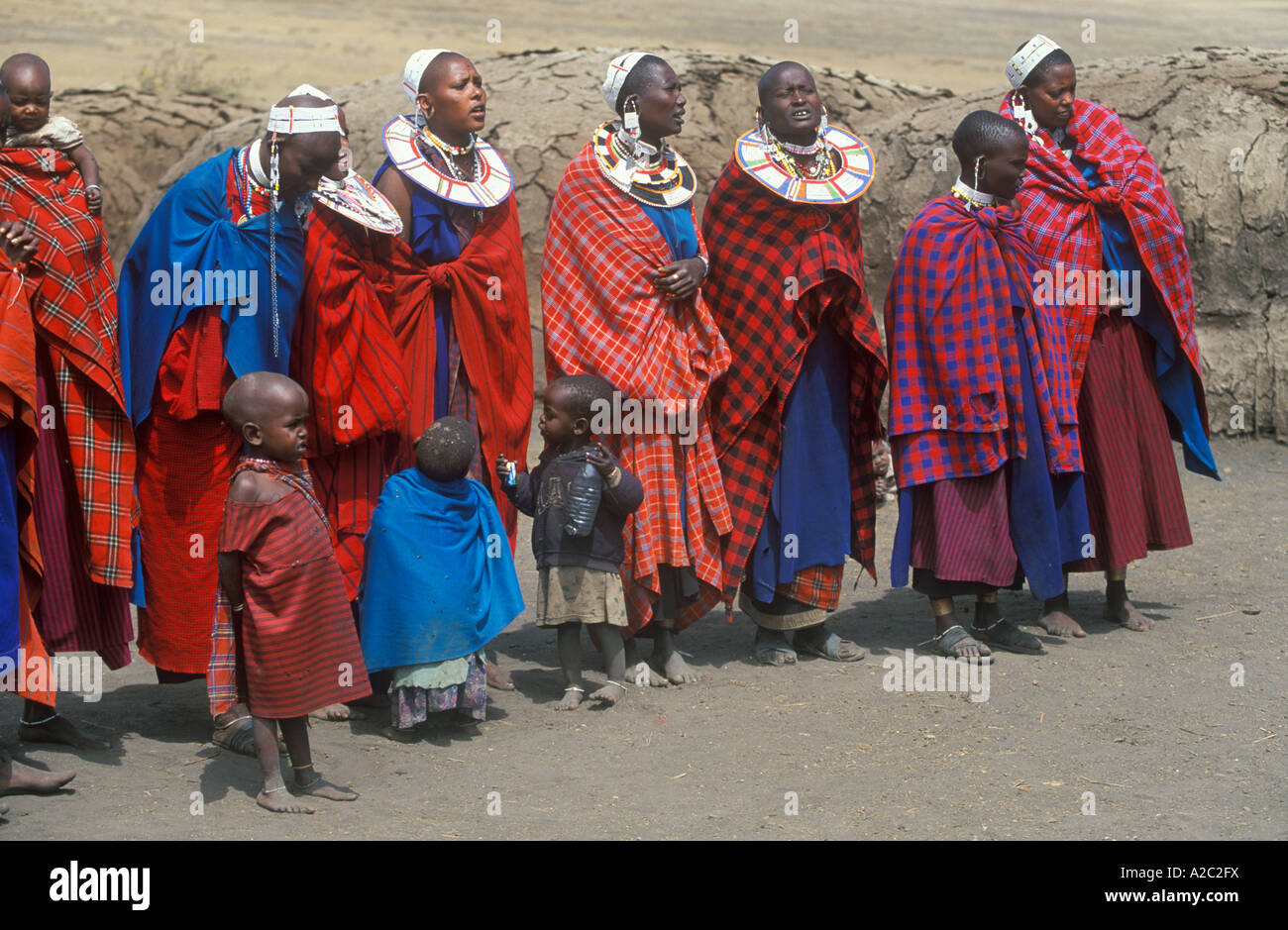 traditionally dressed Masai women with small children at their village ...