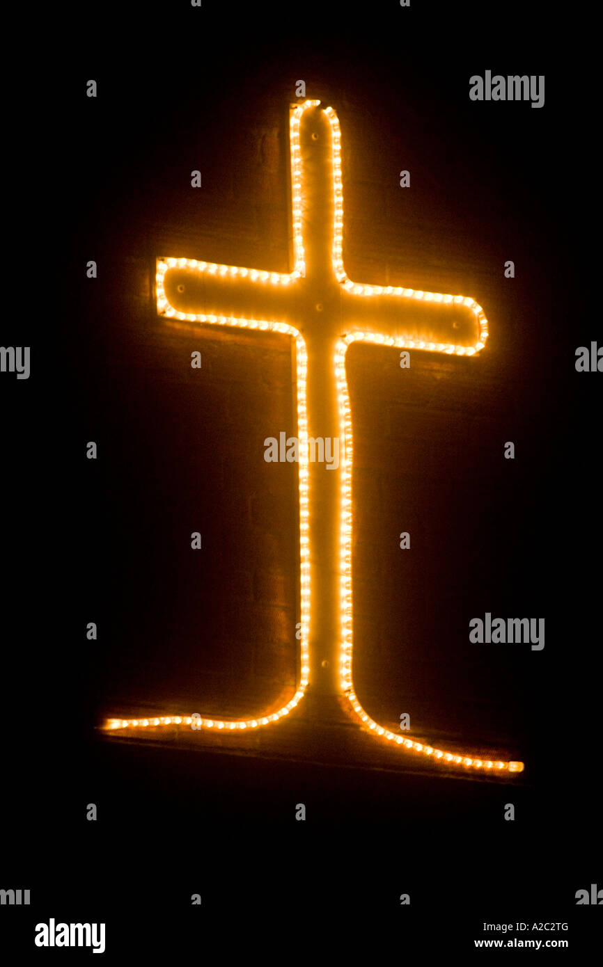 an illuminated cross on a church building Stock Photo - Alamy