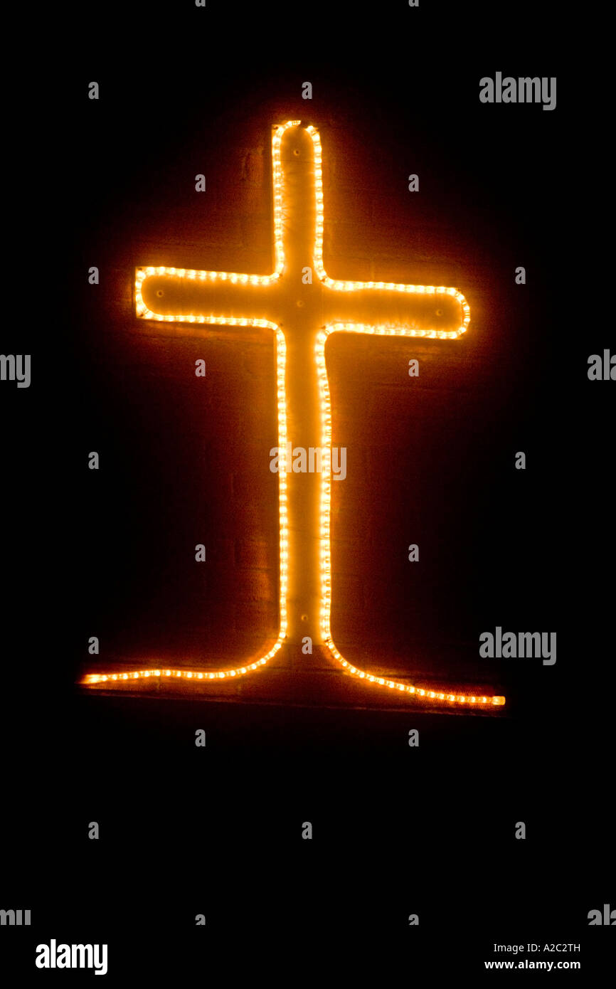 an illuminated cross on a church building Stock Photo - Alamy