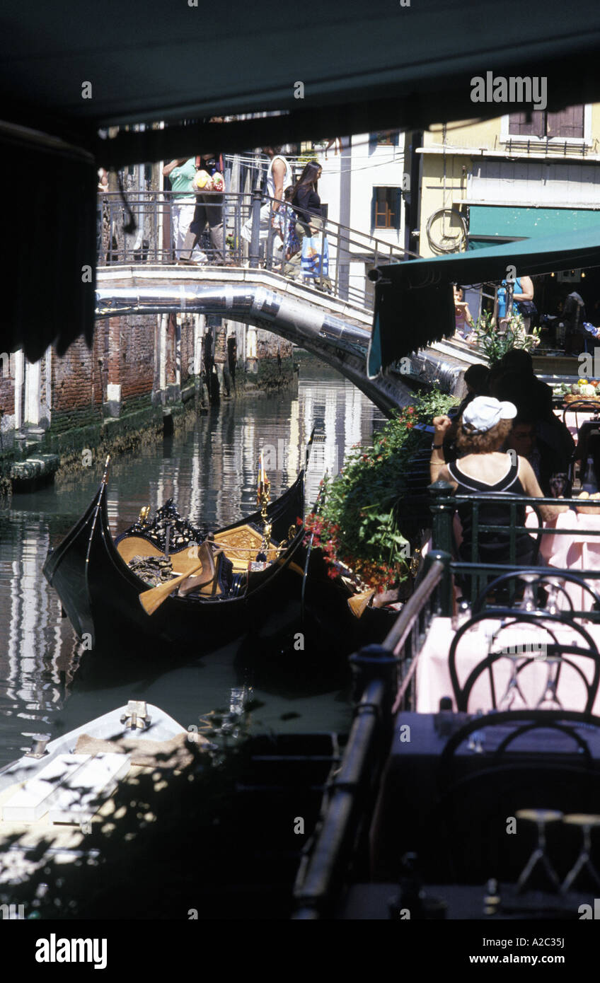 a cafe by a canal and bridge in Venice Italy Stock Photo - Alamy