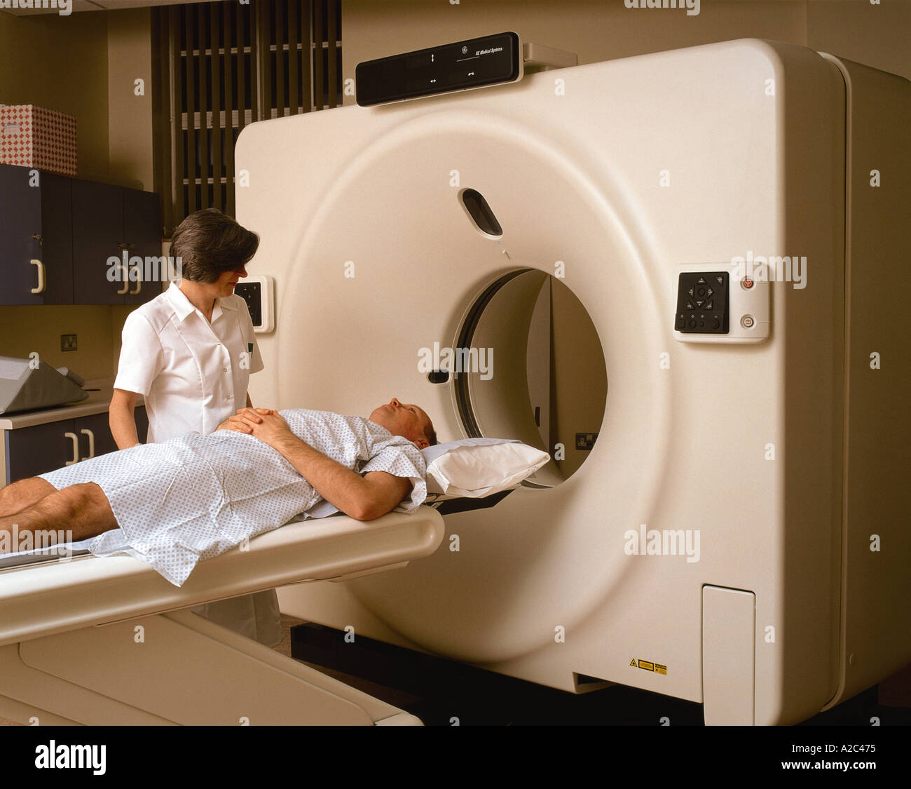 MAN LYING ON STRETCHER ABOUT TO HAVE SCAN WITH NURSE BESIDE HIM Stock ...