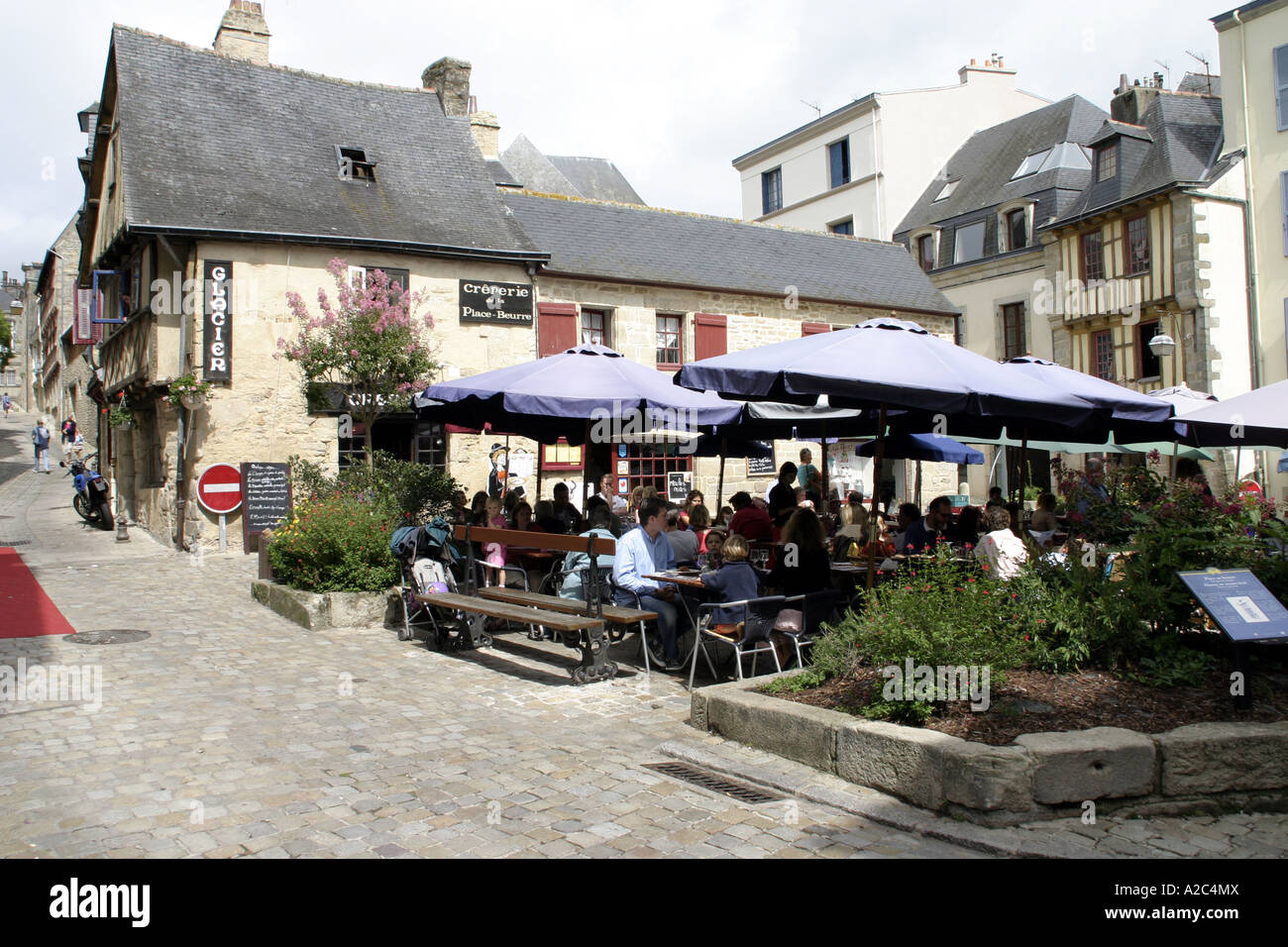 People eating and drinking outside a bar in a square in Quimper ...