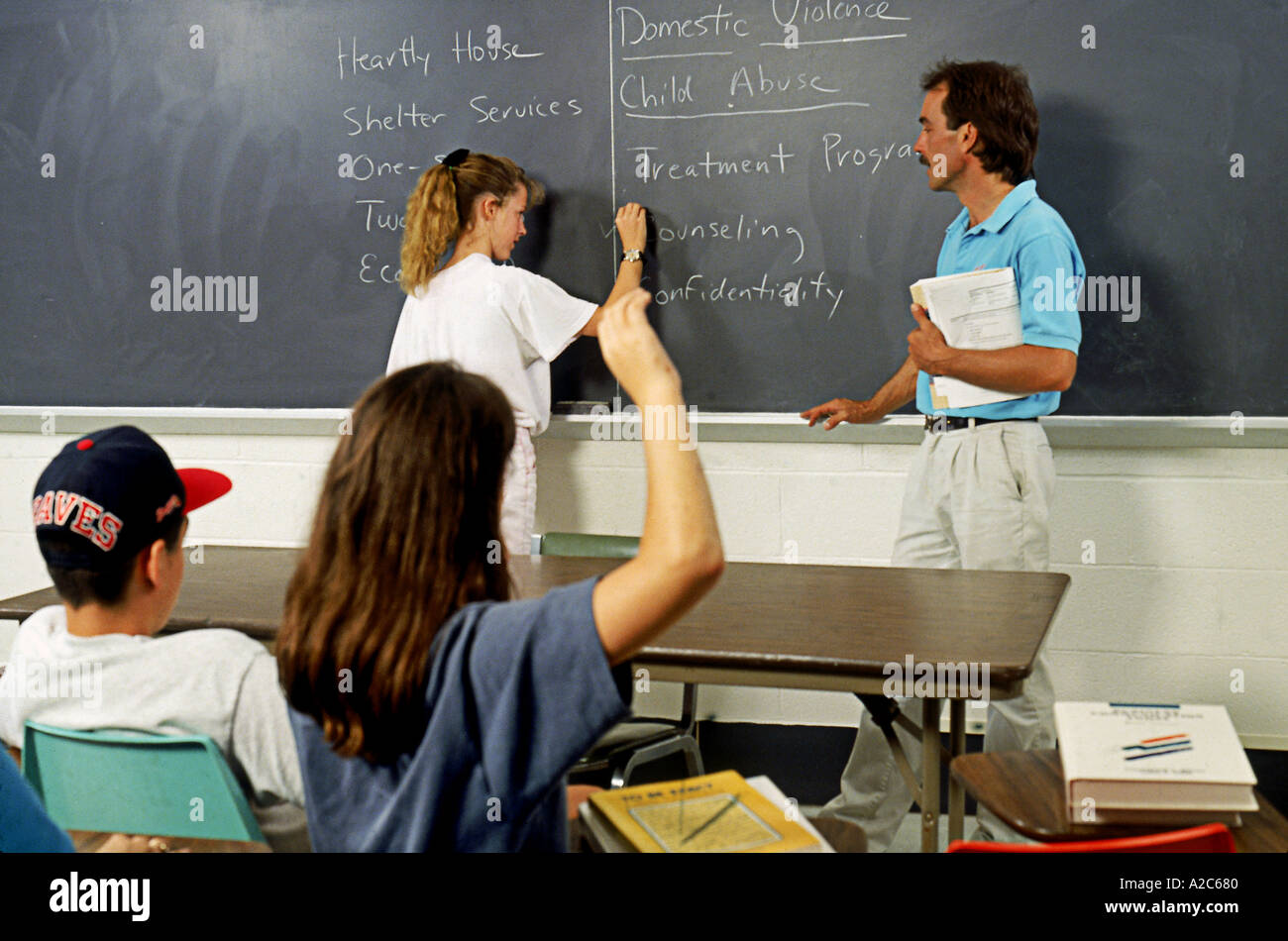 Horizontal shot of students in classroom young girl writing on ...
