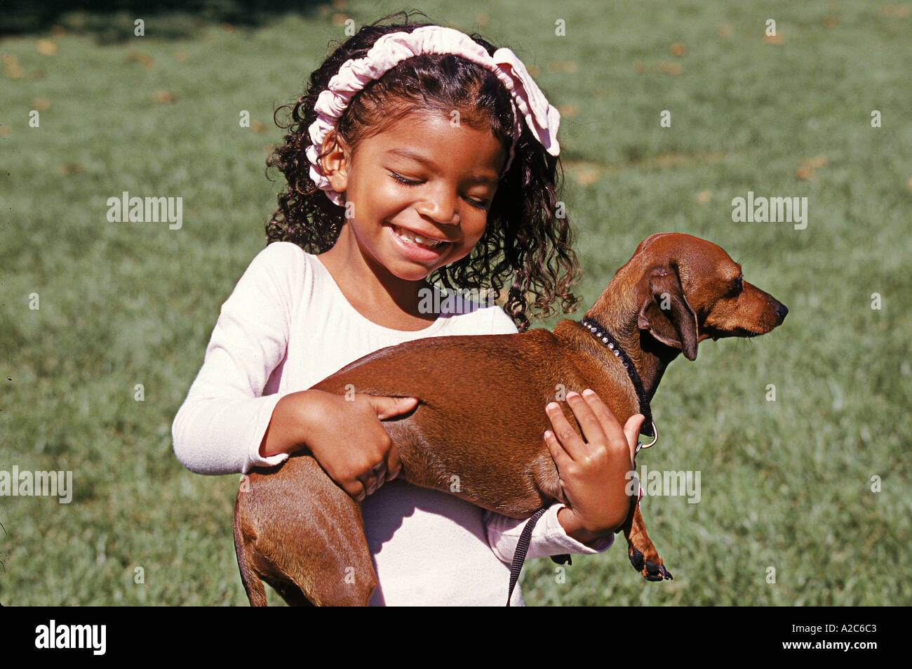 6-7 year old carrying dog front view. MR © Myrleen Pearson ...Ferguson ...