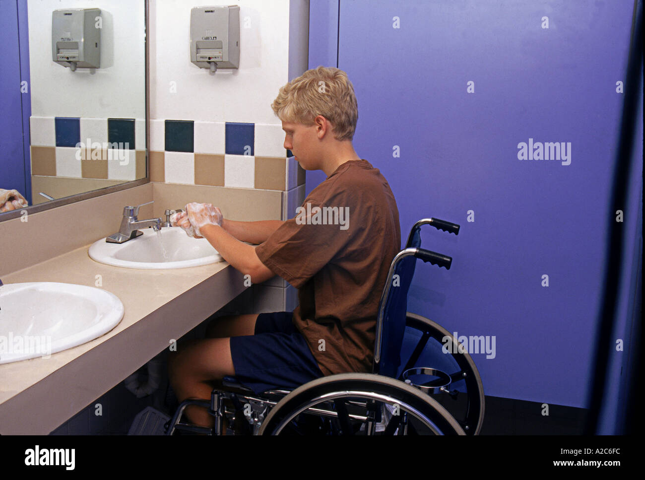 boy in wheelchair washing hands at bathroom sink Stock Photo - Alamy