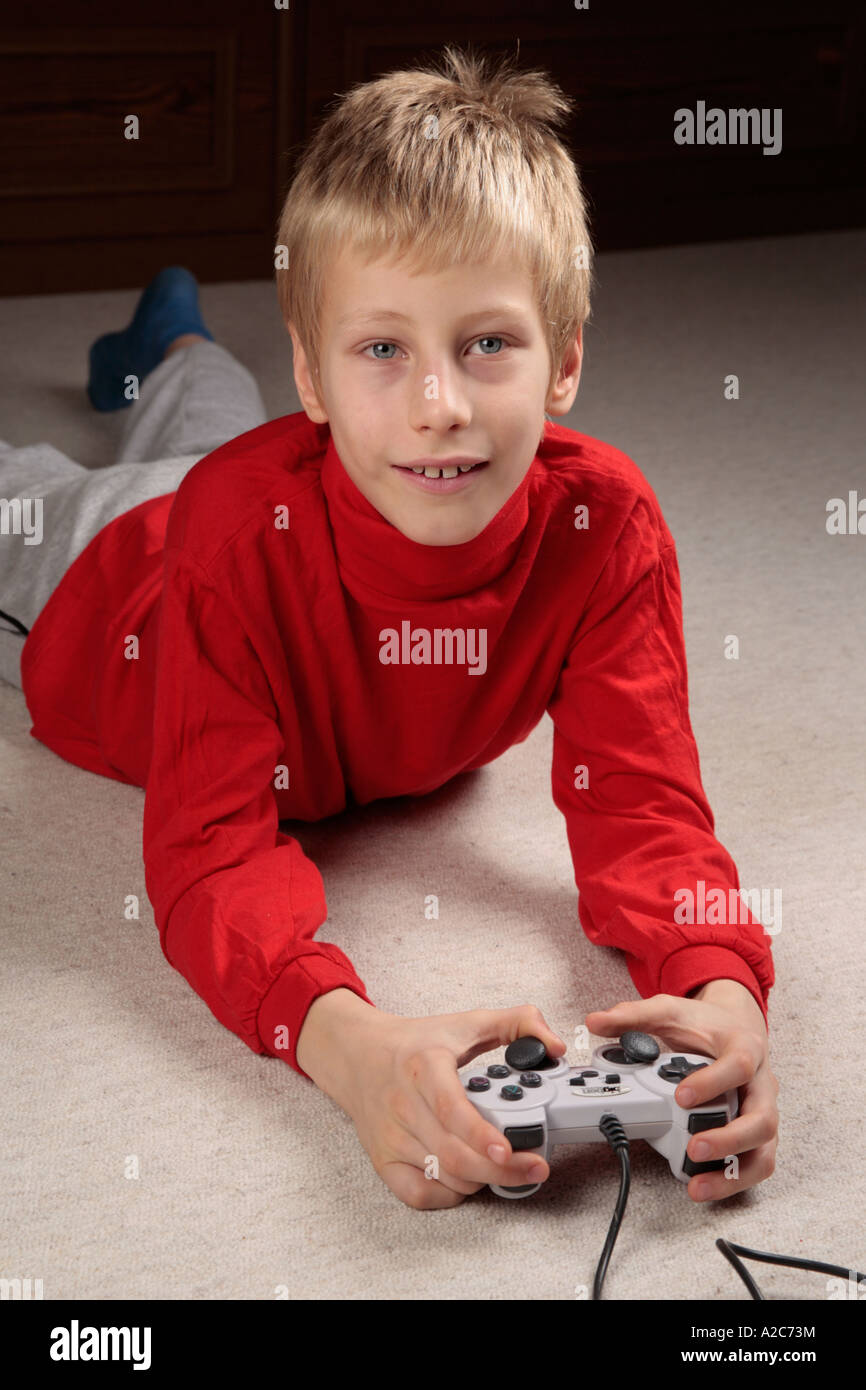 portrait of a young fair boy playing playstation Stock Photo - Alamy