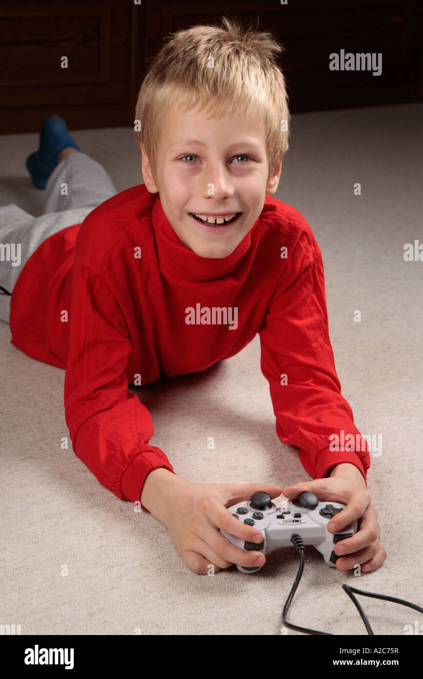 portrait of a young fair boy playing playstation Stock Photo - Alamy