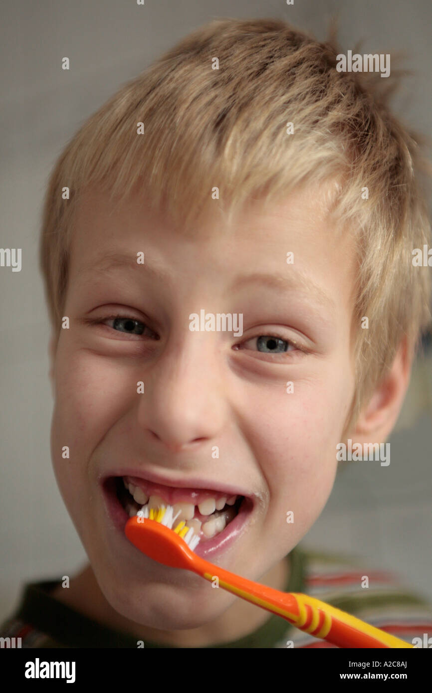 portrait of a young boy brushing his teeth Stock Photo - Alamy