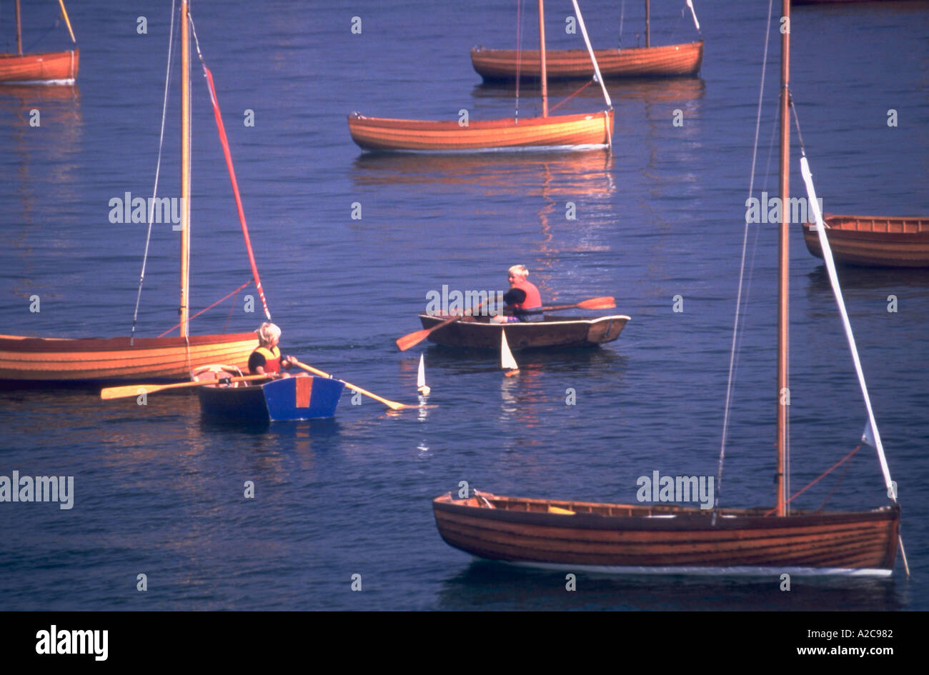 Two children rowing their own little boats among the other empty ...