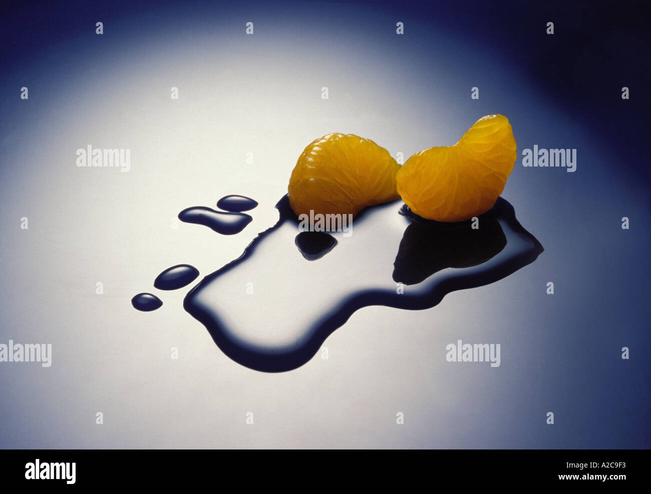 Orange slices, peeled mandarin oranges on blue reflective background ...