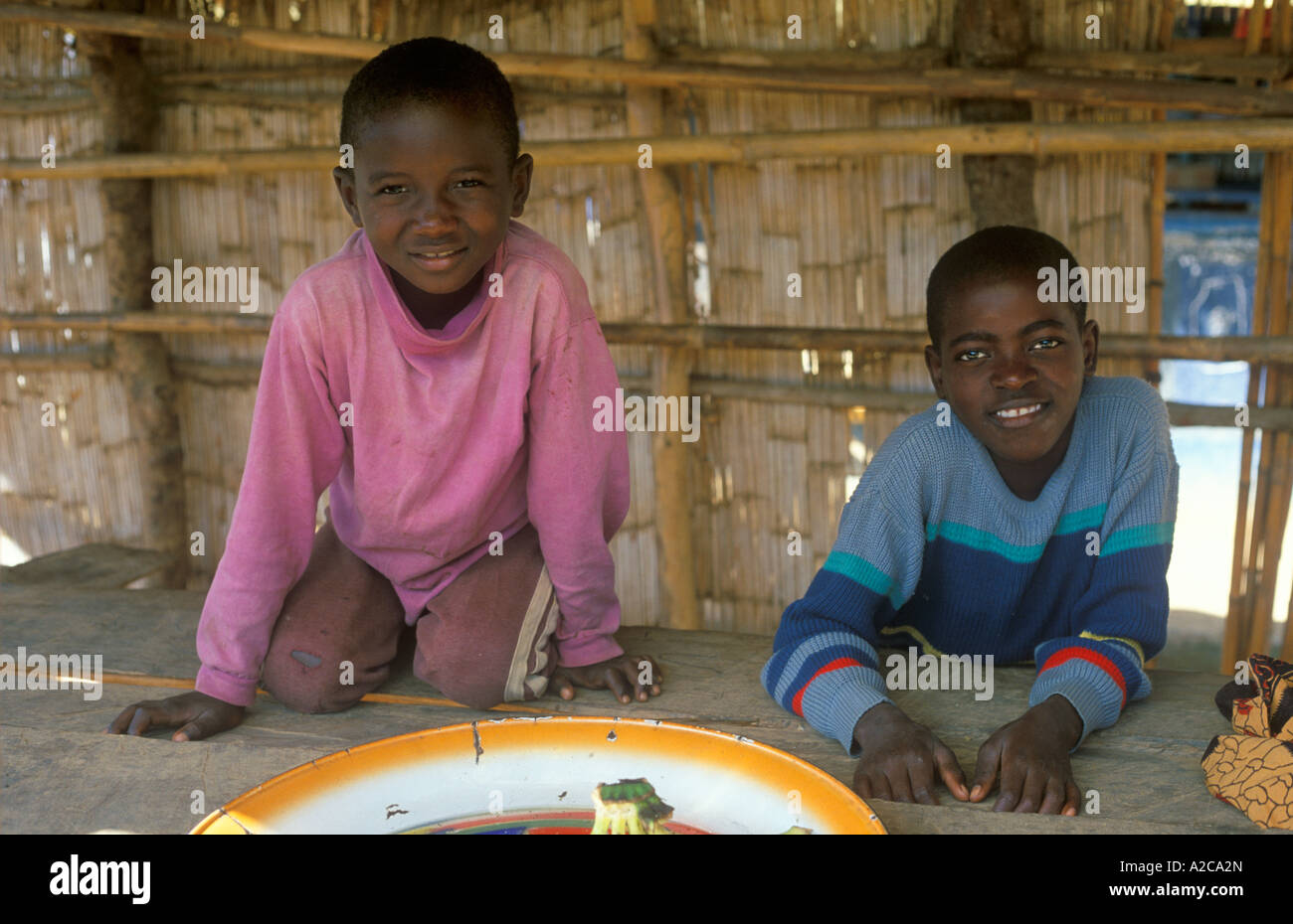 two young boys working in a shop at Kande near Lake Malawi in Africa ...