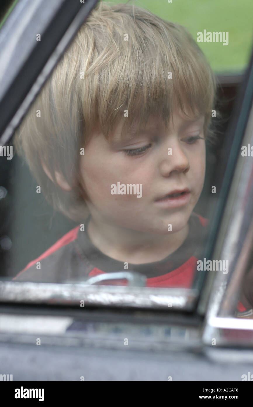 Boy behind car window Stock Photo - Alamy