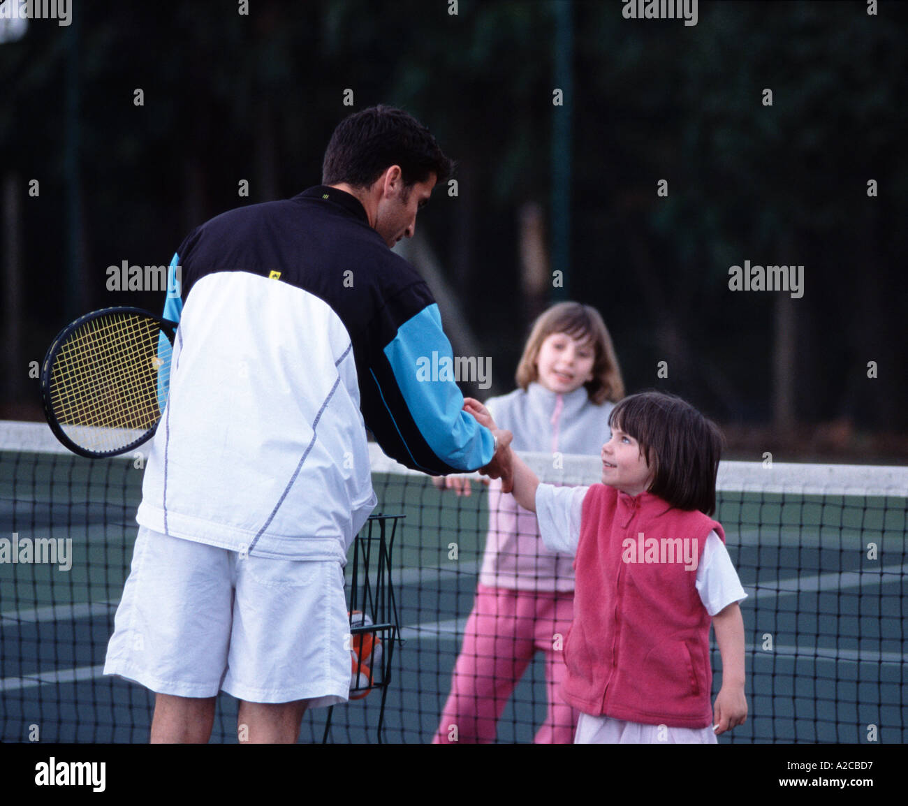 Children s Tennis Lesson two girls aged seven and five Stock Photo - Alamy