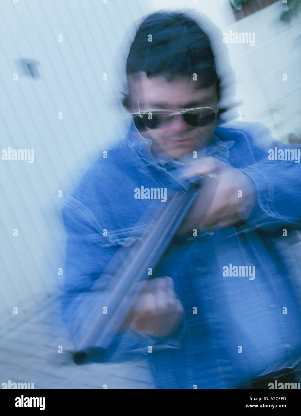 Man pointing and aiming a shotgun Stock Photo - Alamy