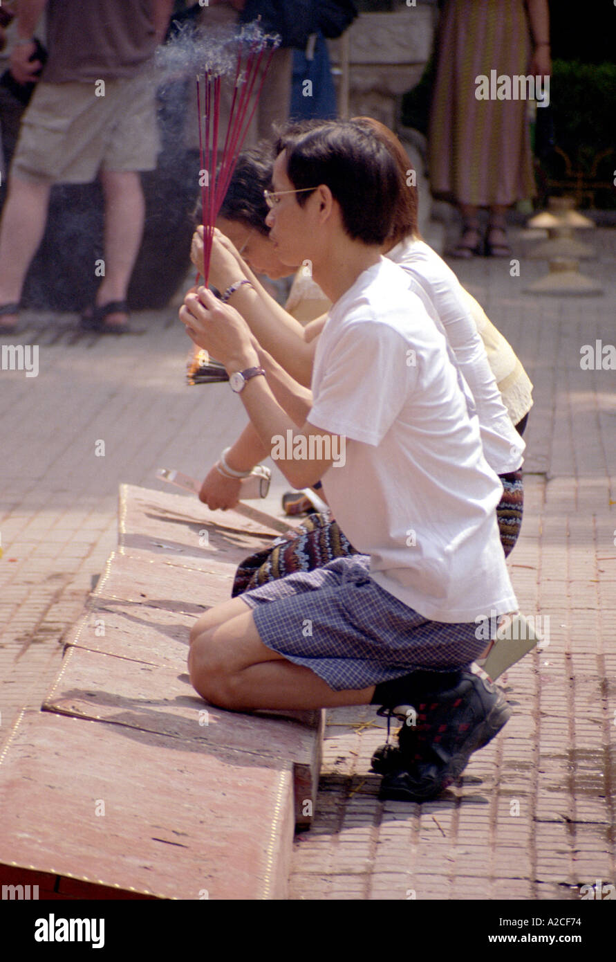 Buddhist devotee kneel down in prayer at Lama Temple in Beijing, China ...