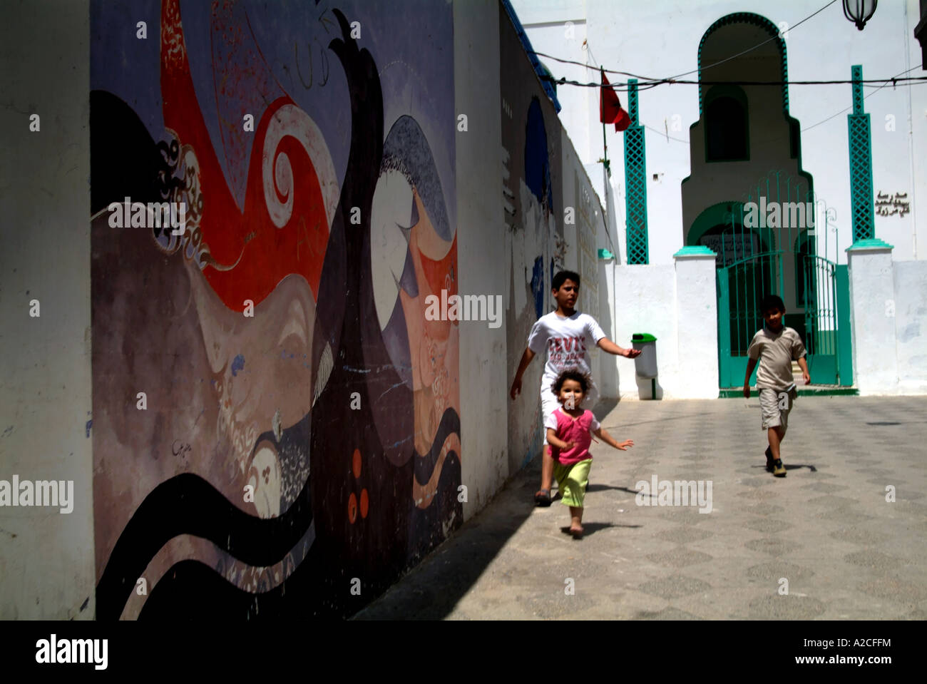 Children running beside modern mural Stock Photo - Alamy
