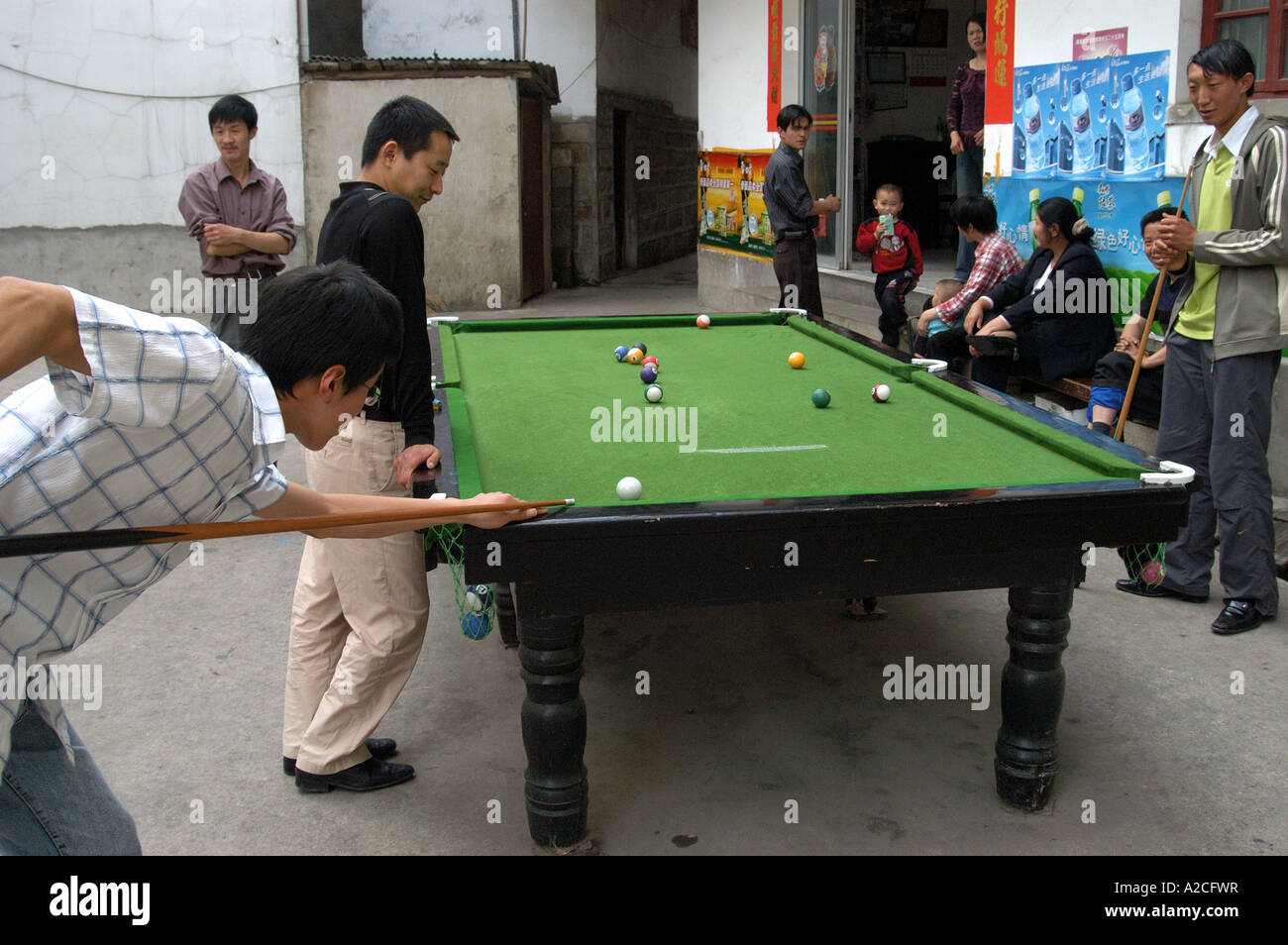Local men playing pool in the village at the foot of Yellow Mountain ...