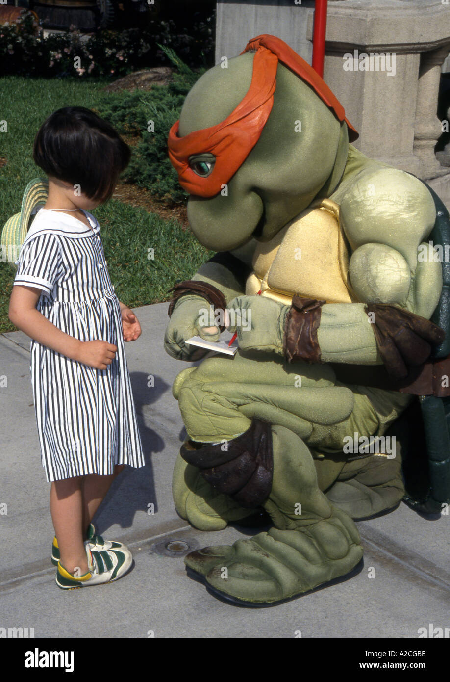 Child meeting mutant hero turtle at MGM studios in Disney theme park ...