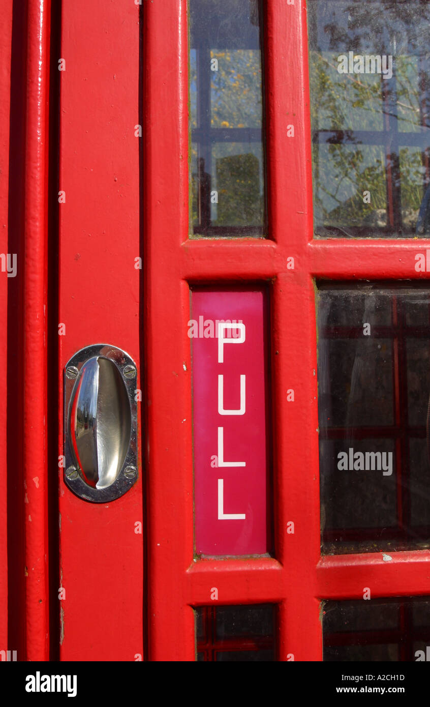 BT red old telephone box payphone box pull door handle on a public ...