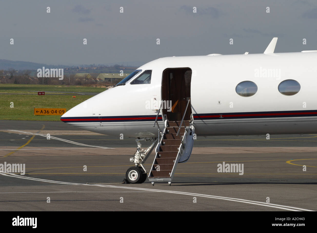 Business executive jet aircraft with passenger door open waiting at an ...