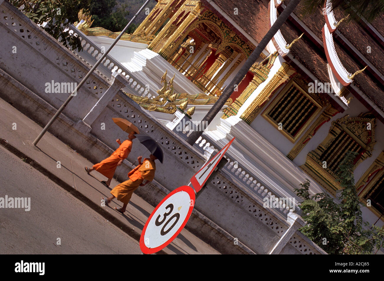 Monks and speed limit road sign Luang Prabang Laos Stock Photo - Alamy