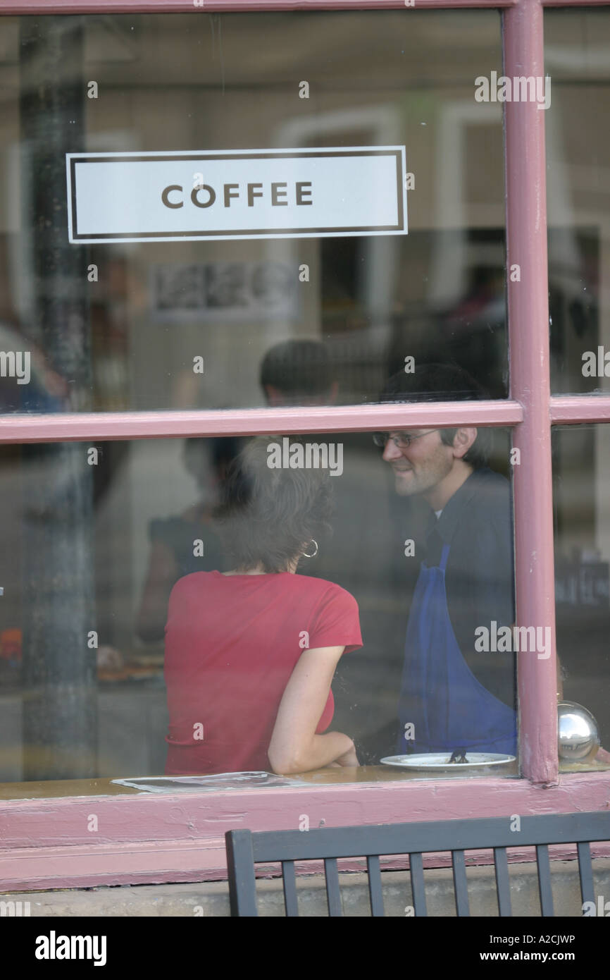 Person relaxing in coffee shop chatting Stock Photo - Alamy