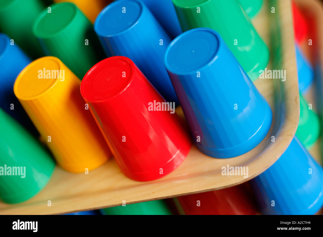 Colourful cups in a school canteen Stock Photo - Alamy