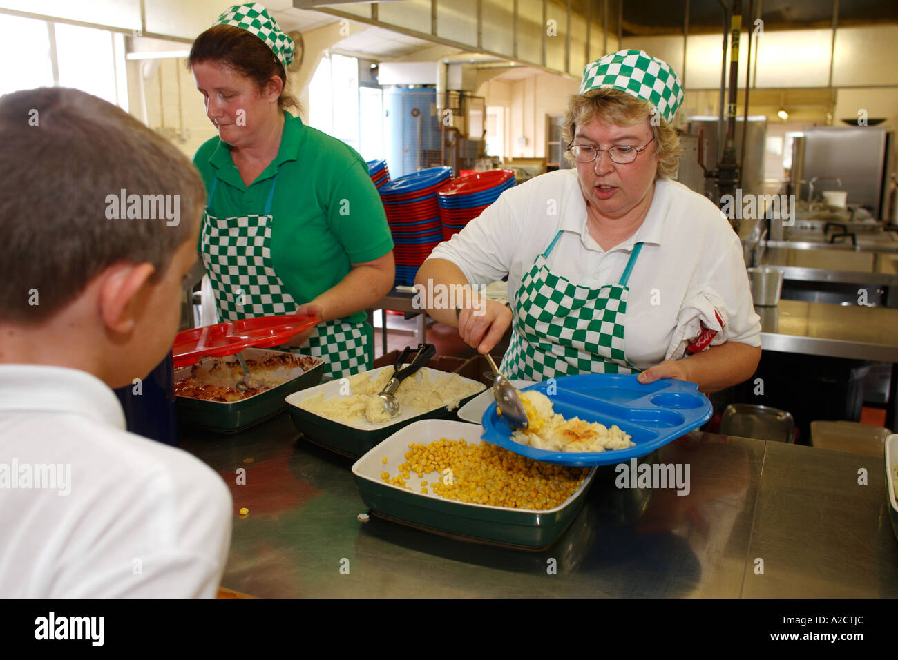 Dinner ladies serving school meals at a school in Exeter Devon UK Stock ...